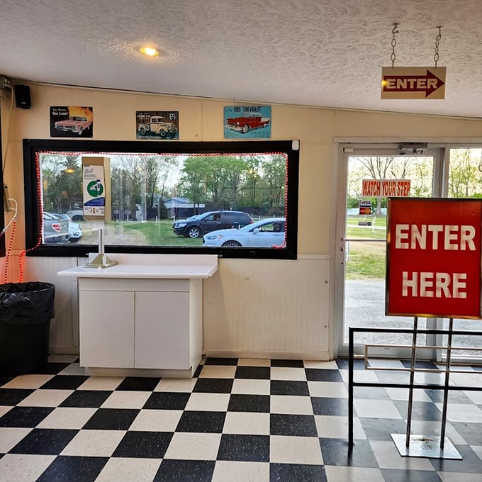 Step back in time at the checkerboard-floored entrance booth. That "ENTER HERE" sign has welcomed generations of moviegoers to their evening escape.