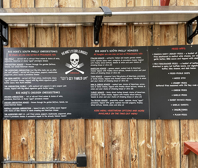 The menu board that launches a thousand cravings. That skull and crossbones logo with "Let's Get Forked Up" tells you they take fun seriously.