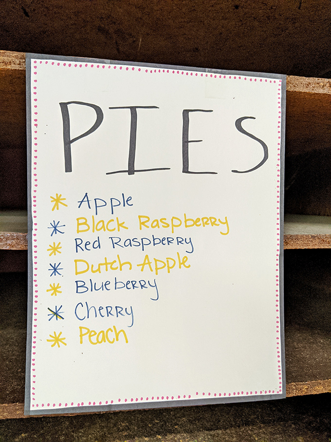 The handwritten pie menu reads like poetry to dessert lovers. Seven varieties of fruit-filled bliss, each one promising a different path to pastry nirvana.