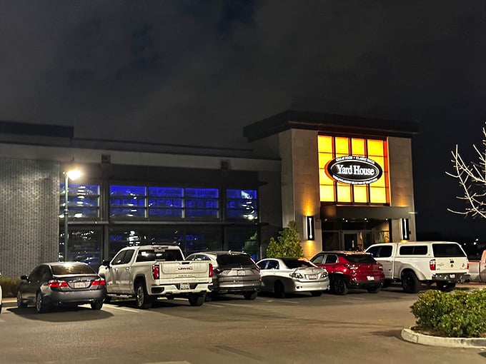 The Yard House's warm glow beckons hungry patrons after sunset—a reminder that good food doesn't need ocean views to satisfy the soul.
