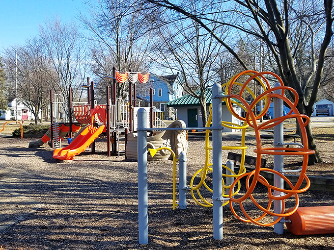 Colorful playground equipment stands ready for childhood adventures, no smartphone app required for this kind of entertainment.