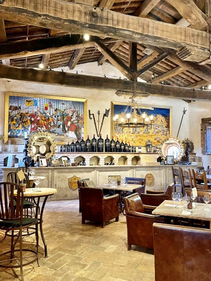 This rustic tasting room with its weathered wooden beams and leather chairs invites you to sip wine like a medieval lord—minus the plague and questionable hygiene.