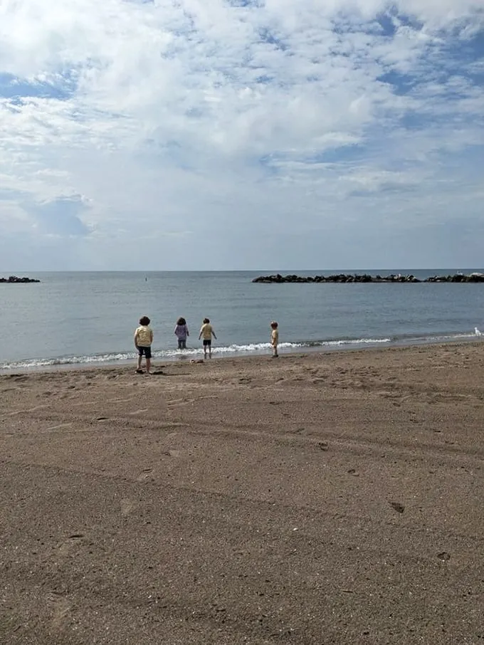 Little explorers test the waters of Lake Erie, proving that childhood wonder needs no ocean—just sand, water, and endless possibilities.