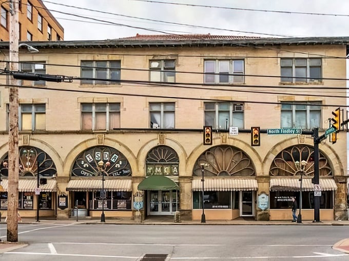 The YMCA building's distinctive arched windows aren't just pretty—they're portals to a time when buildings had character and social security checks could actually secure something.
