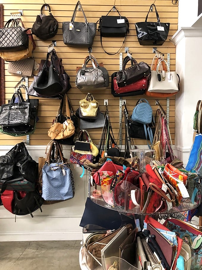 The handbag wall—where designer dreams come true without the nightmare credit card statements that usually follow.