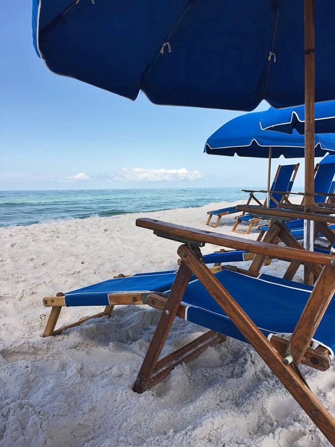 The unofficial Seagrove office setup—wooden chairs, azure umbrellas, and the world's most spectacular view. No TPS reports required.