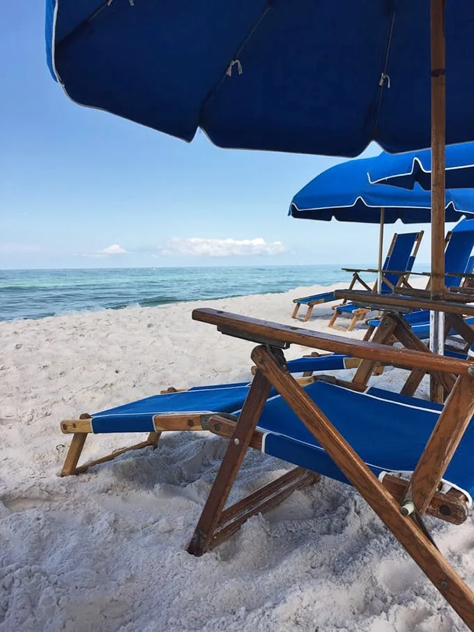 The unofficial Seagrove office setup—wooden chairs, azure umbrellas, and the world's most spectacular view. No TPS reports required.
