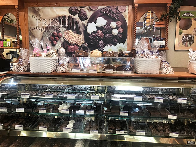 Chocolate temptation at its finest. This display case is where diets go to die and shopping energy gets replenished—a delicious pit stop between purchases.