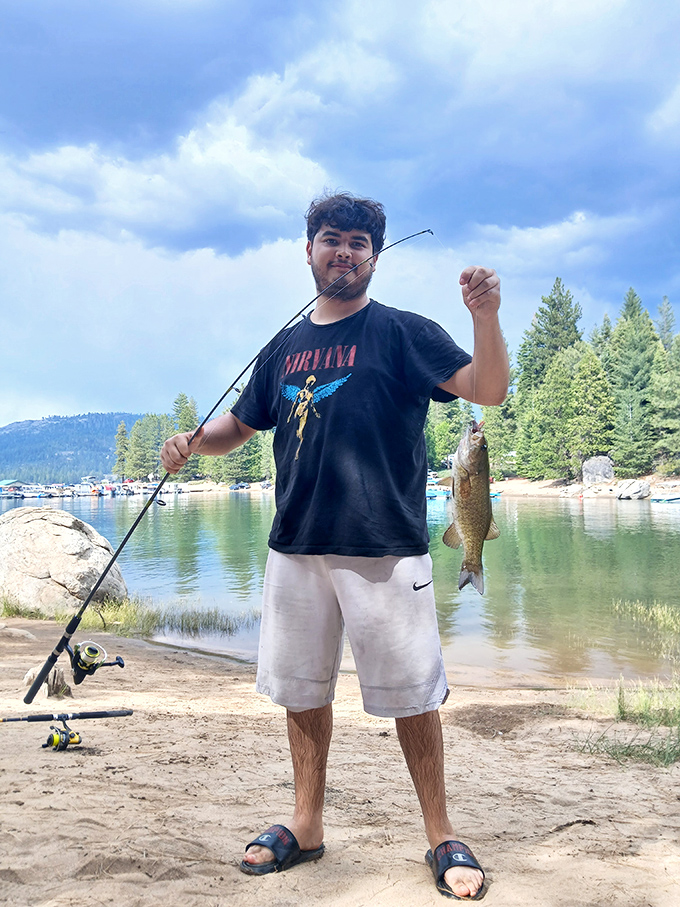 Young angler proves that patience pays off, even when your fish photobombs your victory pose.
