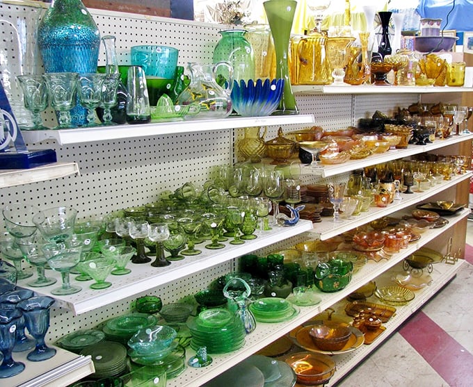 A rainbow of vintage glassware catches the light like jewels. Grandma's punch bowl collection has nothing on this kaleidoscopic display of drinkware history.