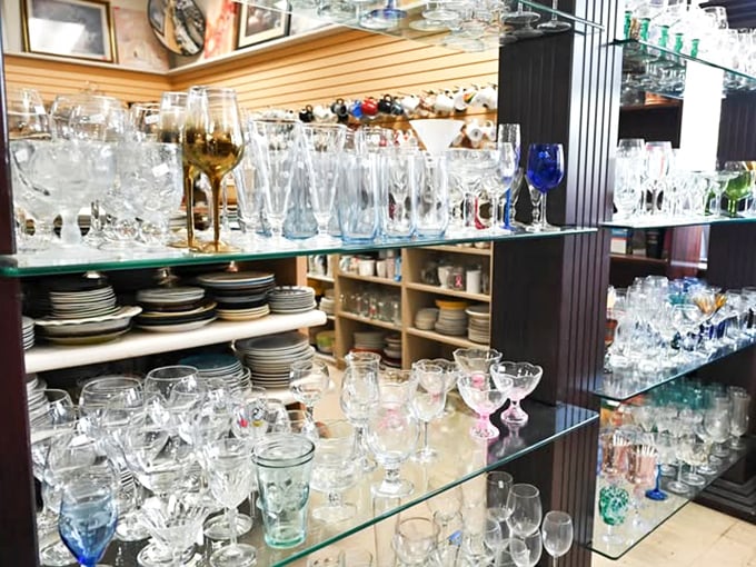 Crystal goblets catching light alongside everyday tumblers—a sparkling display that would make any dinner party host weak at the knees.