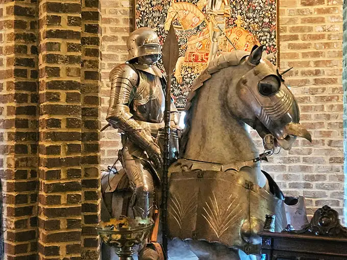 This knight isn't horsing around! A magnificent suit of armor stands eternally vigilant against the castle walls, ready for a joust or perhaps just a photo opportunity.