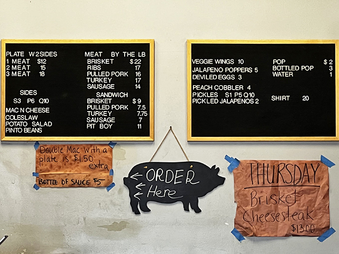 The chalkboard menu speaks the universal language of barbecue devotees—meat by the pound, classic sides, and daily specials that inspire regular pilgrimages.