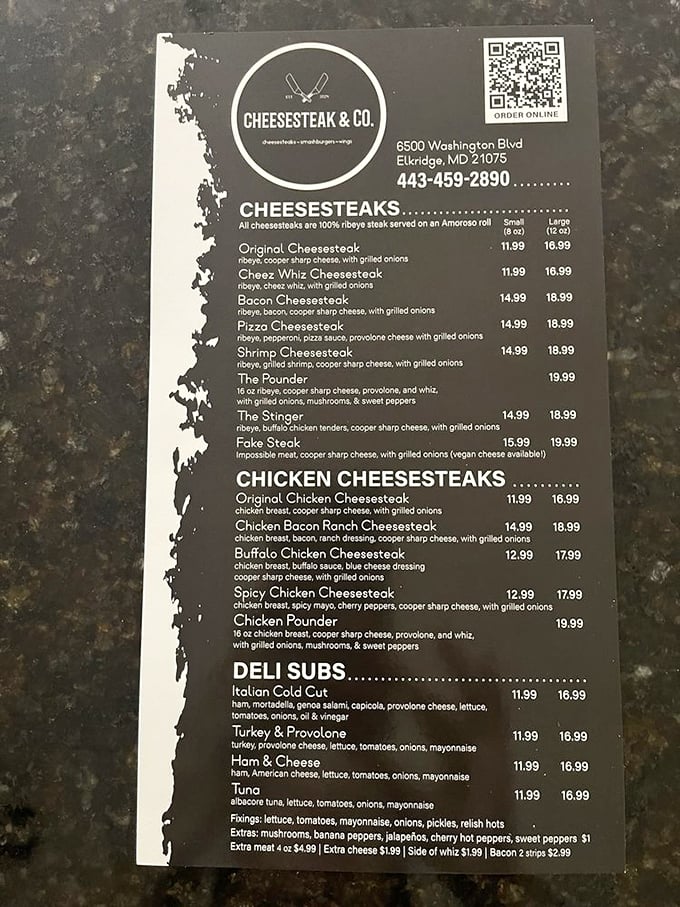 The menu board reveals the holy grail of cheesesteak authenticity: 100% ribeye on Amoroso rolls. Philadelphia's influence is alive and well in Maryland.