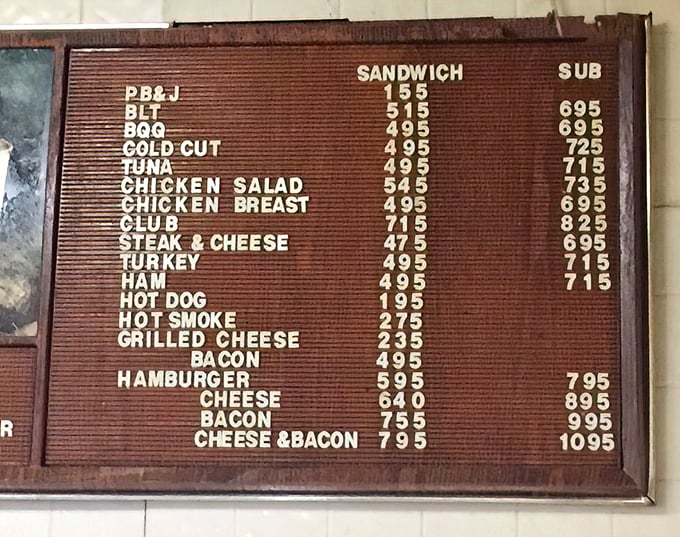 The menu board speaks the universal language of comfort food. Simple choices, honest prices, and the legendary bacon cheeseburger hiding in plain sight.