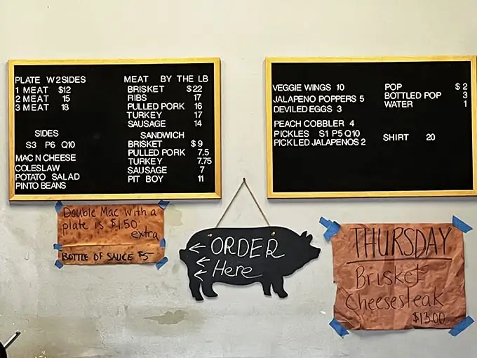 A menu board that cuts right to the chase. No fancy descriptions or culinary buzzwords—just the promise of smoked meat excellence.