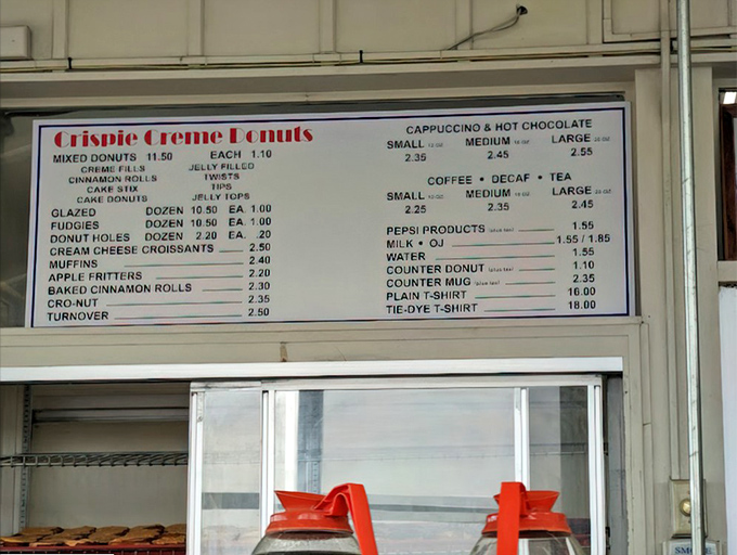 The menu board tells a beautiful story of simplicity – no fancy names, just honest donuts at honest prices.