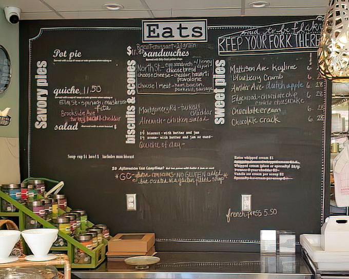 The chalkboard menu reads like poetry for the hungry—savory pies, quiches, and sweet treasures await your eager fork.