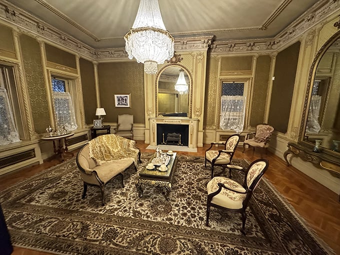 This isn't just a living room—it's a masterclass in early 20th century opulence, where that chandelier alone probably cost more than my first house