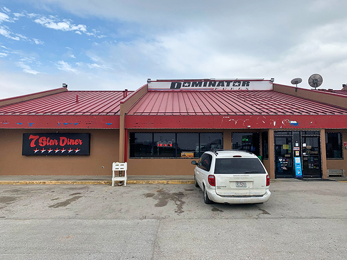 The 7 Star Diner's bright red roof serves as both landmark and promise – comfort food awaits inside, where calories don't count and coffee cups are never empty.