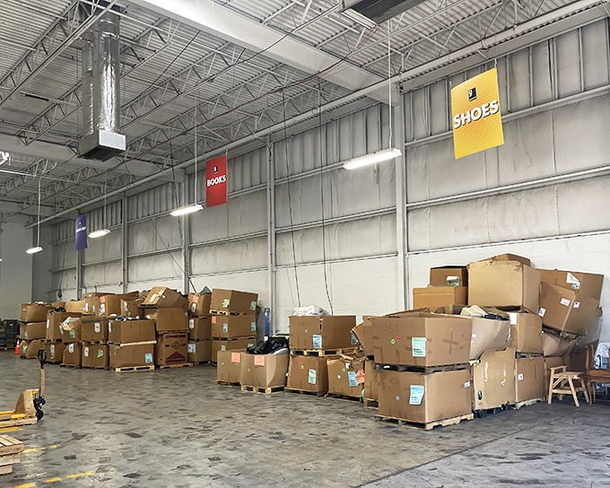 Beyond these stacked boxes lie literary treasures and footwear finds waiting for their perfect match—archaeological digging tools recommended.