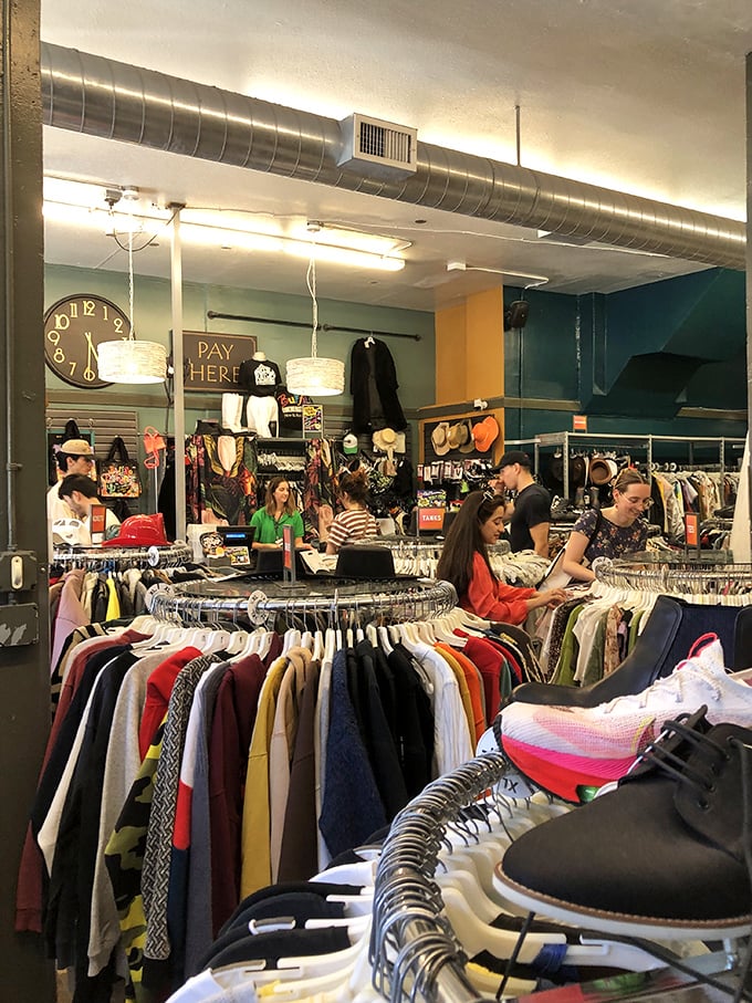 The thrill of the hunt in action—shoppers navigate the carefully curated wilderness of pre-loved fashion with focused determination.