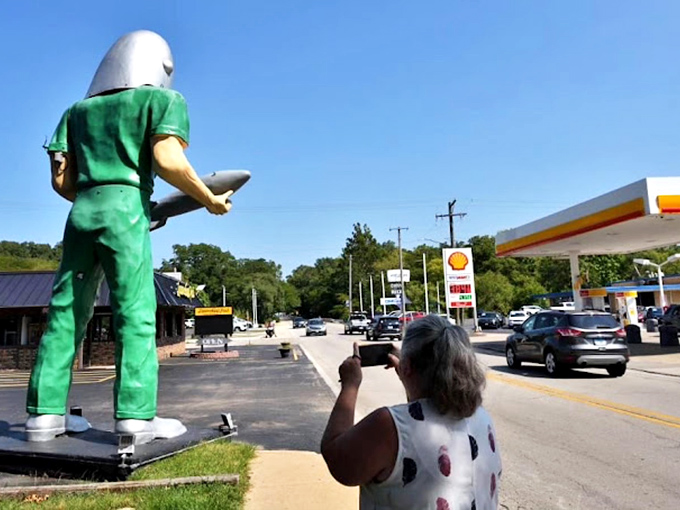 Even from behind, our cosmic friend maintains the dignified stance of someone who's been holding that rocket since the Space Race.