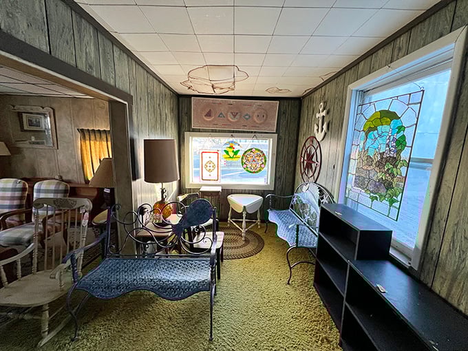Nautical dreams come alive in this wood-paneled room where stained glass windows cast kaleidoscope patterns across vintage maritime treasures.