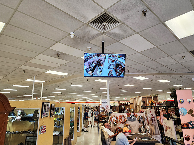 Security monitors keep watch while shoppers hunt for treasures. That gentleman might just be finding the vinyl record that defined his youth.