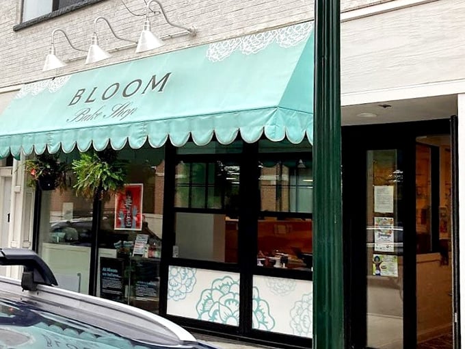 Bloom's mint-green awning signals an oasis of sweetness, like finding a secret garden where the flowers are made of dough and frosting.