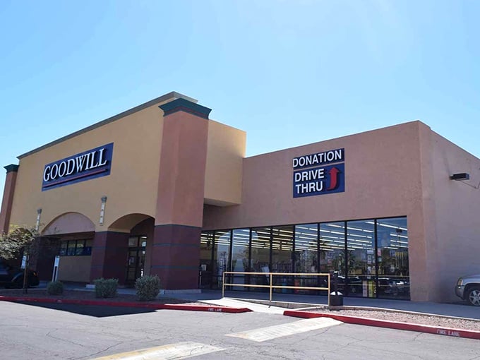 Goodwill's familiar blue sign glows against the twilight sky, a beacon for night owls hunting for that perfect vintage find.