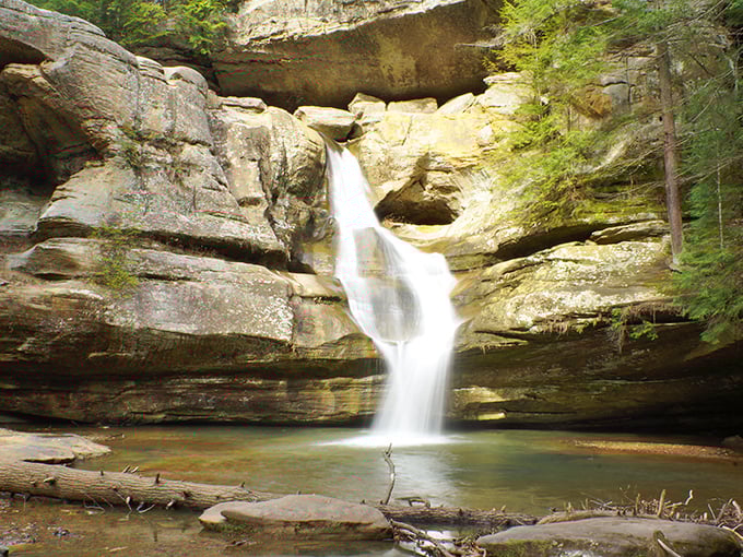 Hocking Hills: Mother Nature showing off again! This waterfall tumbles through ancient rock formations, creating a scene straight from a fantasy novel.