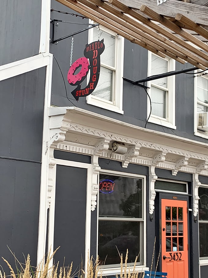 Navy blue building, bright orange door – Diablo knows dramatic entrances matter almost as much as their heavenly donuts.