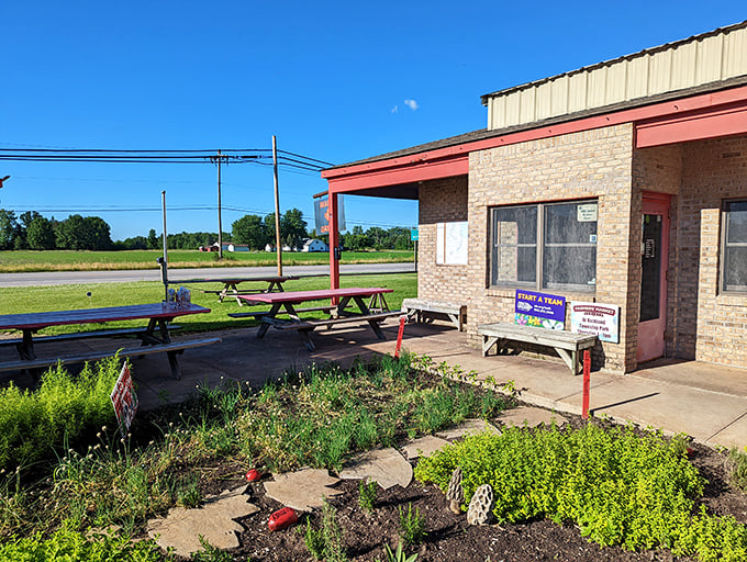 Simple picnic tables outside The Maple Grille tell you this place cares more about flavor than fancy. Wood-fired goodness awaits!