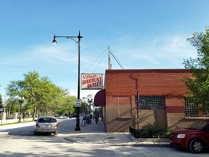 Sunshine and savings at Village Discount Outlet. That vintage sign has guided thrifters to bargains for decades.