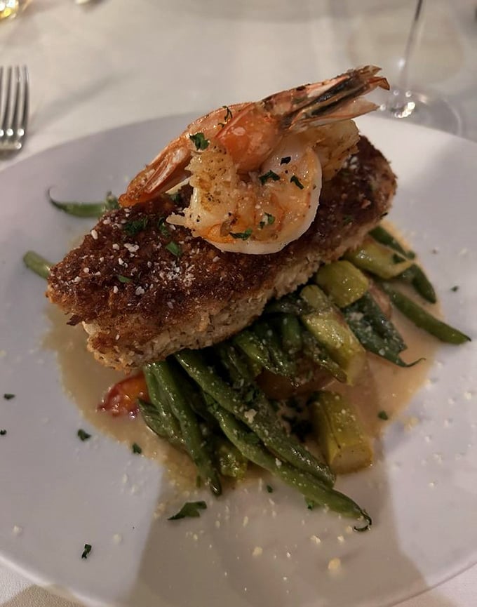 Not just another fish dish—this perfectly crusted grouper topped with a plump shrimp is what happens when the ocean's finest ingredients meet culinary artistry.