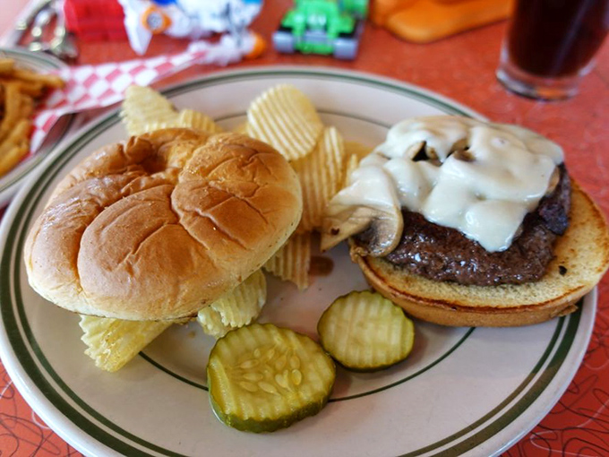 This isn't just a burger – it's a masterpiece of melted cheese cascading over a perfectly seared patty. The pickles add that essential tang.
