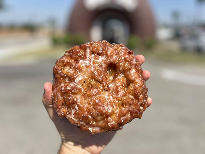 This apple fritter isn't just breakfast—it's edible architecture, a caramelized cathedral of cinnamon-spiced apple chunks that shatters gloriously with each bite.