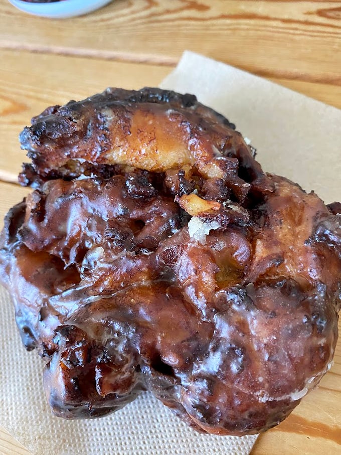 This apple fritter isn't just a pastry, it's architecture – a caramelized cathedral of apple-cinnamon glory that demands reverence.