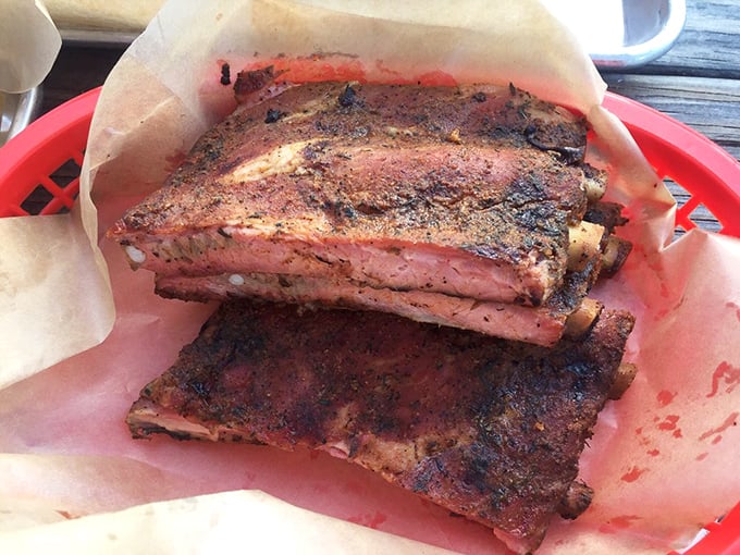 These ribs don't just fall off the bone – they perform a graceful swan dive into barbecue immortality with that perfect pink smoke ring.