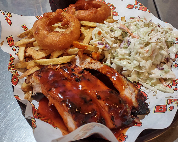 BBQ perfection doesn't happen by accident. These ribs, paired with golden onion rings, crispy fries, and creamy coleslaw, are what food dreams are made of.