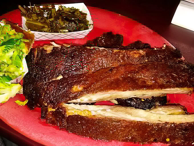 These ribs don't just fall off the bone—they practically leap into your mouth, their smoke ring a badge of honor earned through patience.
