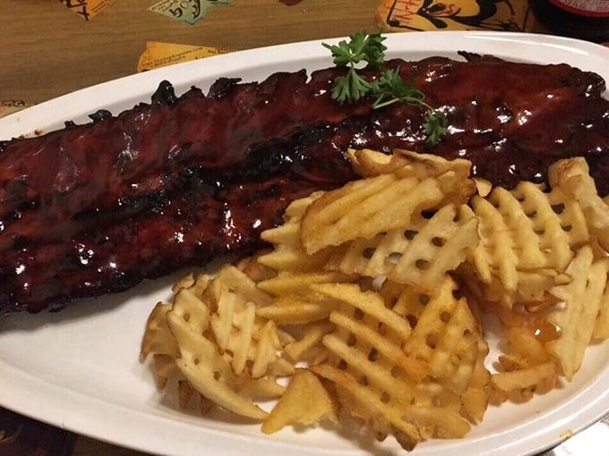 These aren't just ribs; they're glistening monuments to smoke and patience, flanked by waffle fries that refuse to be mere sidekicks.