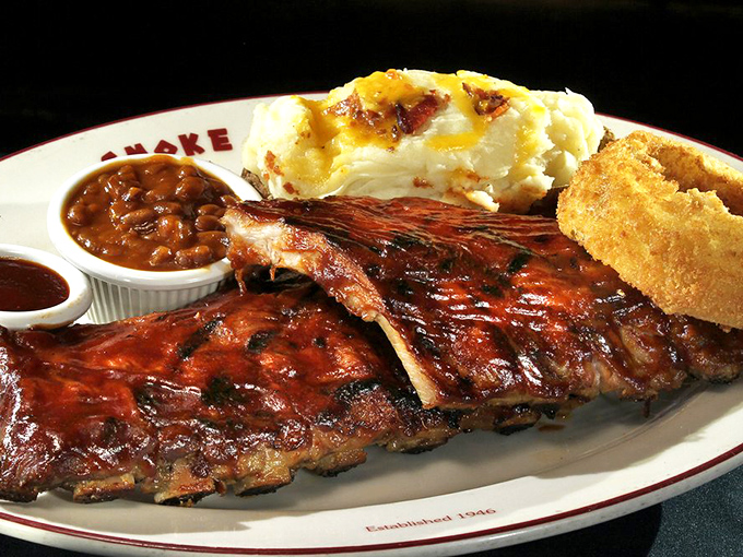 BBQ ribs that don't just fall off the bone—they practically leap onto your fork. Served with sides that know their supporting role perfectly.