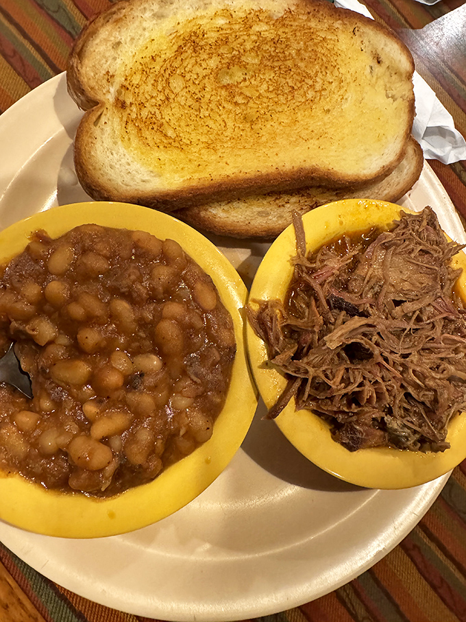 Baked beans and pulled pork – a marriage so perfect it makes you wonder why we bother with fancy cuisine. That toast? Just there to soak up the glory.