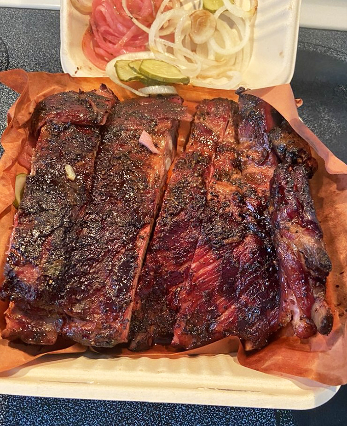 These ribs don't just fall off the bone—they practically leap into your mouth with that perfect bark and smoke ring that would make a pitmaster weep.