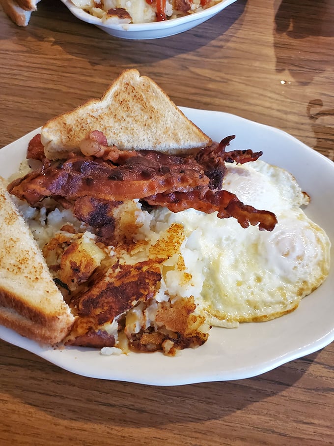 Breakfast perfection doesn't need fancy plating—just perfectly crisp bacon, golden home fries, and eggs that sunshine on your plate.