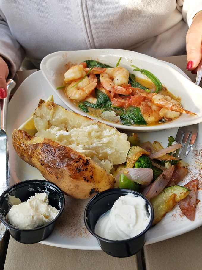 This isn't just a baked potato—it's a canvas for culinary creativity, accompanied by plump shrimp that would make any seafood lover swoon.