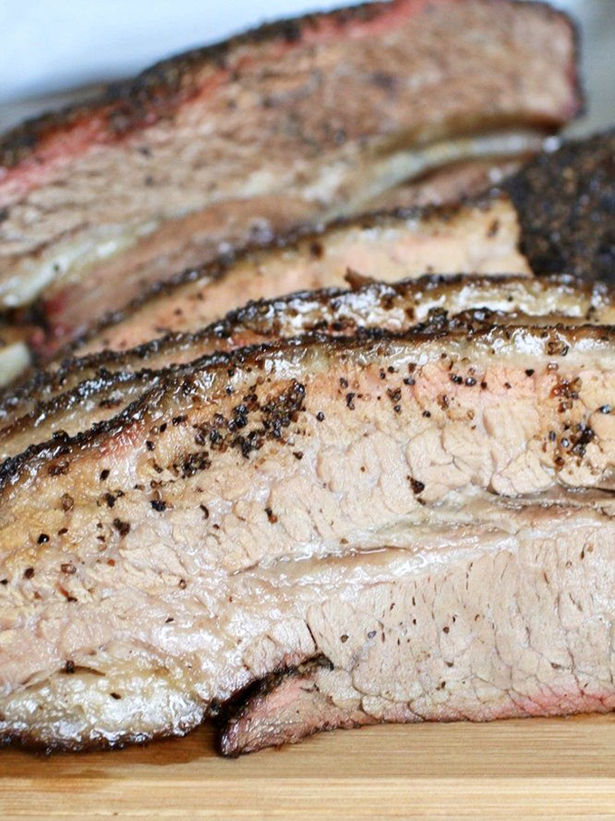 Brisket so tender it practically surrenders to your fork. That pink smoke ring is the barbecue equivalent of a Michelin star.