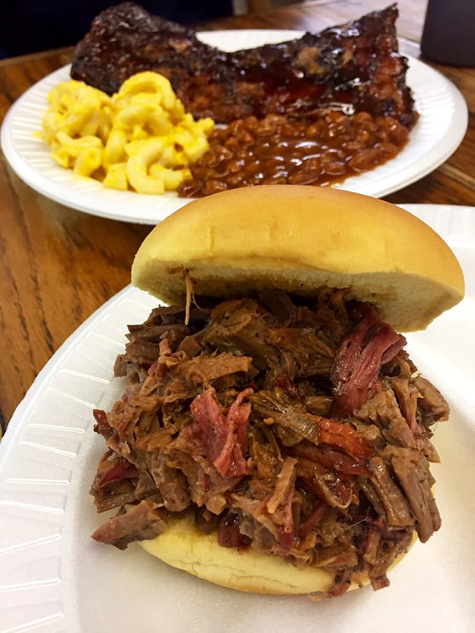 Meat masterpiece alert! This pulled pork sandwich isn't just food – it's edible art, with tender strands of smoky goodness piled high on a pillowy bun.